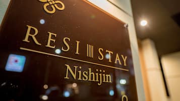 Um letreiro com o texto 'RESI STAY Nishijin'.