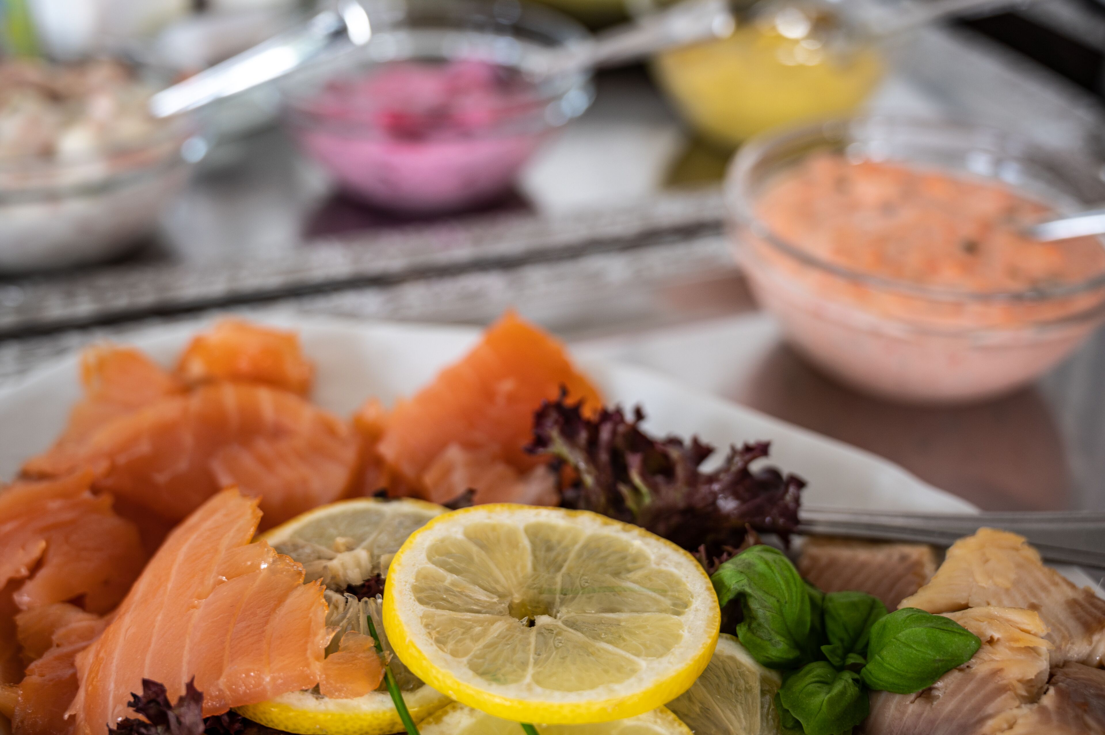 Prato de salmão defumado com fatias de limão e vegetais.