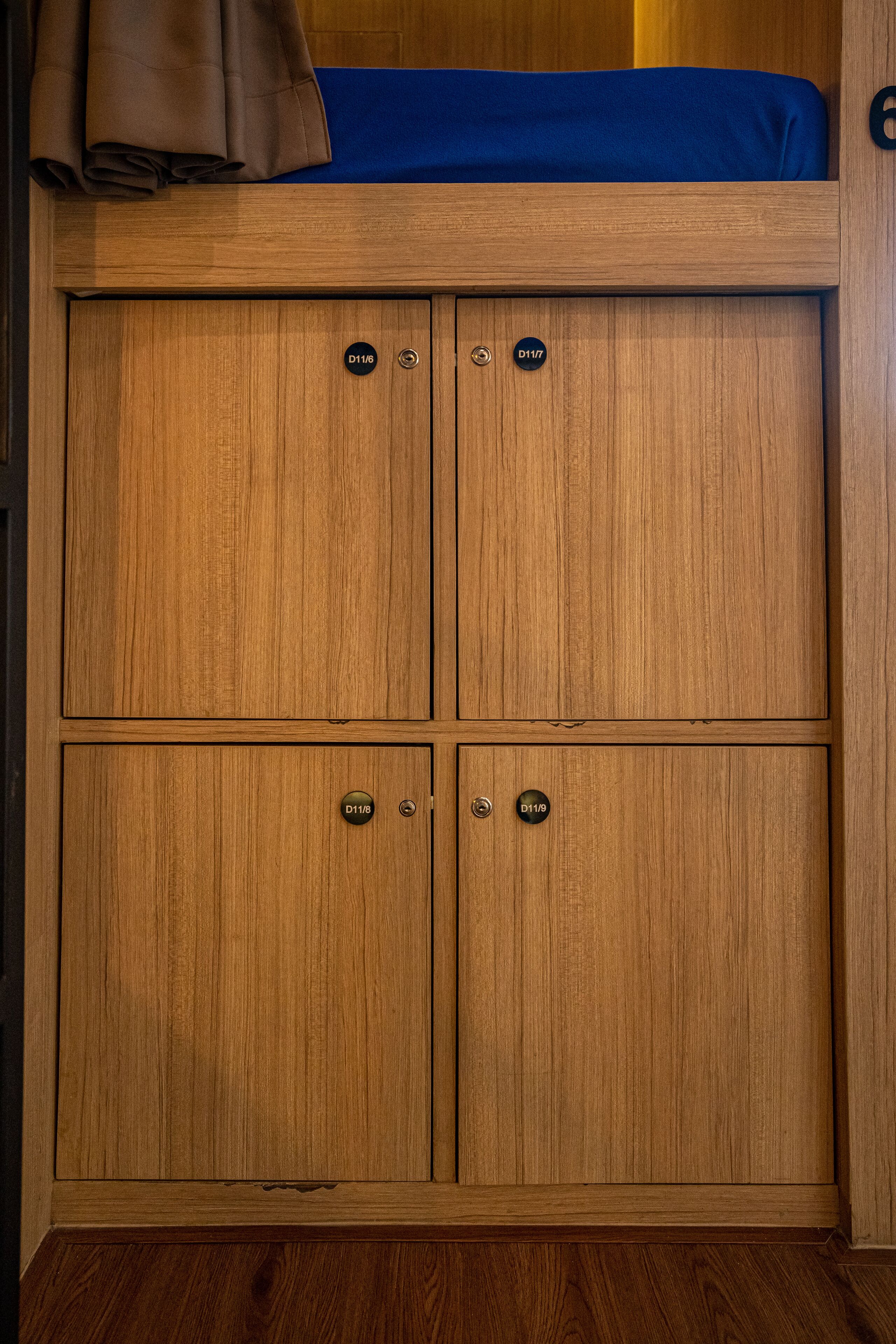 Um guarda-roupa de madeira com quatro portas, cada uma identificada com um número.