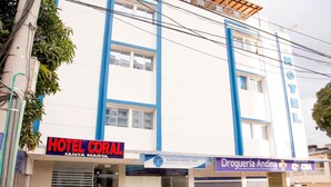 Um hotel chamado HOTEL CORAL com uma placa para SANTA MARIA.