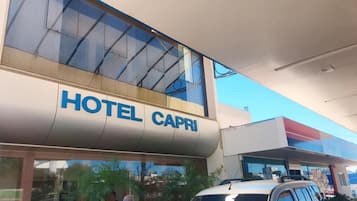 A modern building with a sign reading "HOTEL CAPRI".