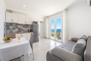 Apartamento, vista para o mar | Cozinha privada | Geladeira, micro-ondas, cooktop, chaleira elétrica