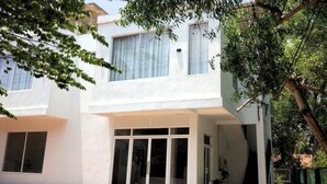 Um edifício moderno de dois andares, com grandes janelas e entrada coberta.