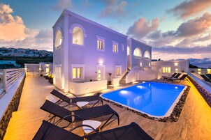 Uma villa moderna com piscina, área de estar externa e escadaria que leva ao andar superior.