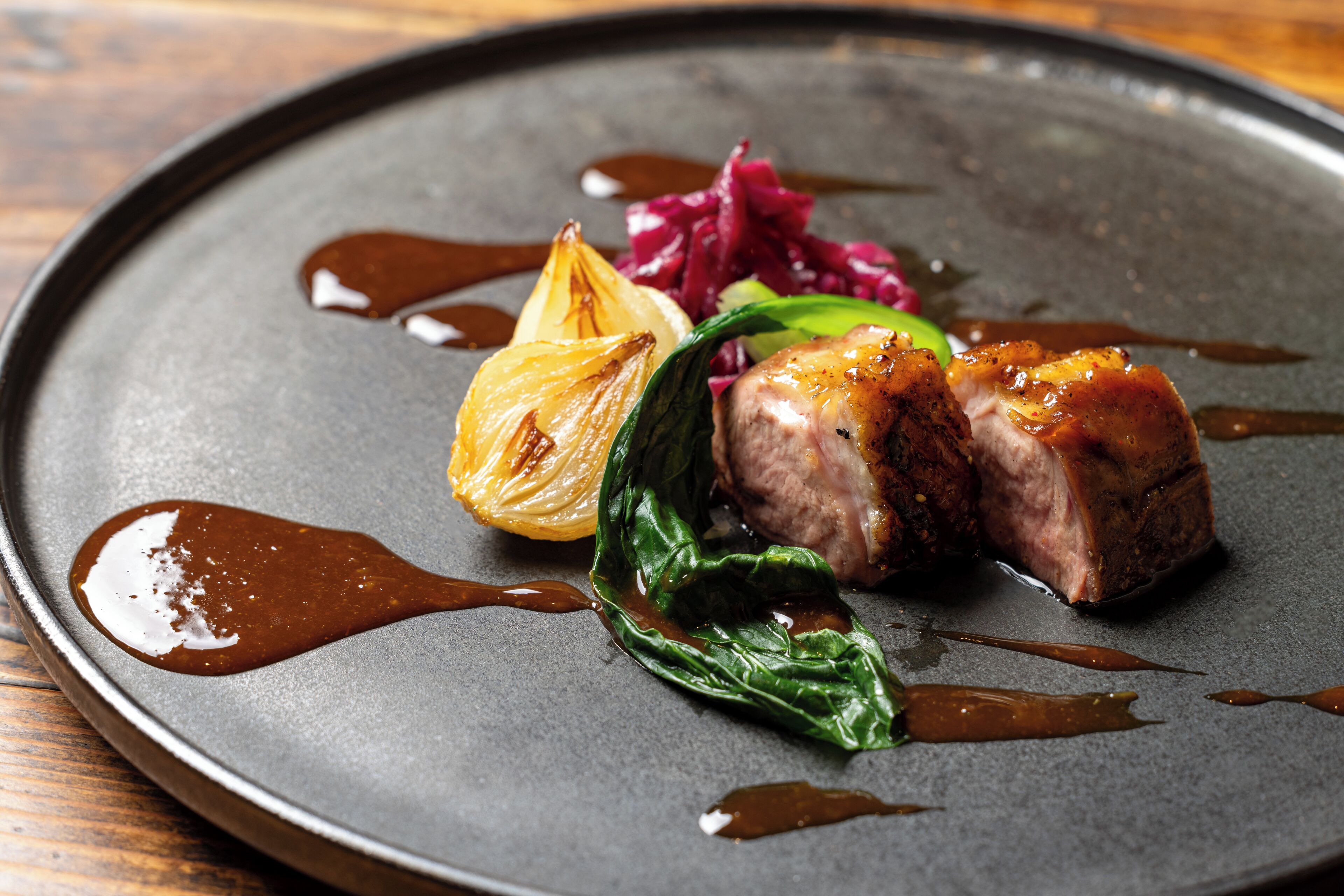 Um prato com carne, legumes e molho.
