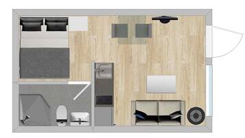 Quarto de hotel compacto com cama, um pequeno espaço de estar, cozinha compacta e banheiro.