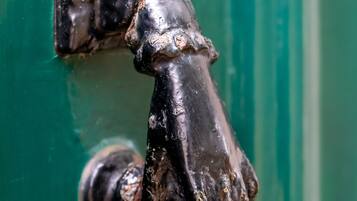 Um close-up de um puxador de porta com sinais de desgaste e ferrugem.