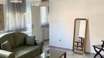 Apartamento, 1 cama queen-size | Sala de estar | TV de ecrã plano
