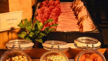 Buffet com diversas opções de comida, incluindo frutas secas, nozes e granola.