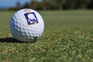 Uma bola de golfe em um campo gramado.