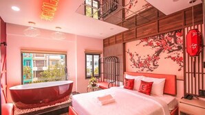 Quarto moderno com cama grande, banheira e vista para o exterior.
