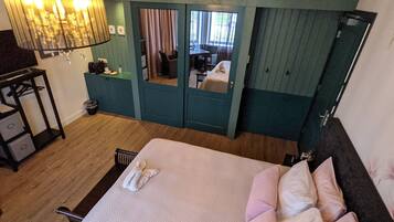 Quarto com cama, mesa de cabeceira e espelho.