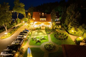 Hotel com estacionamento, área de estar ao ar livre e jardins bem cuidados.