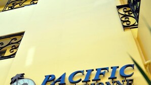 Um edifício com uma placa que diz 'PACIFIC PENSIONNE'.