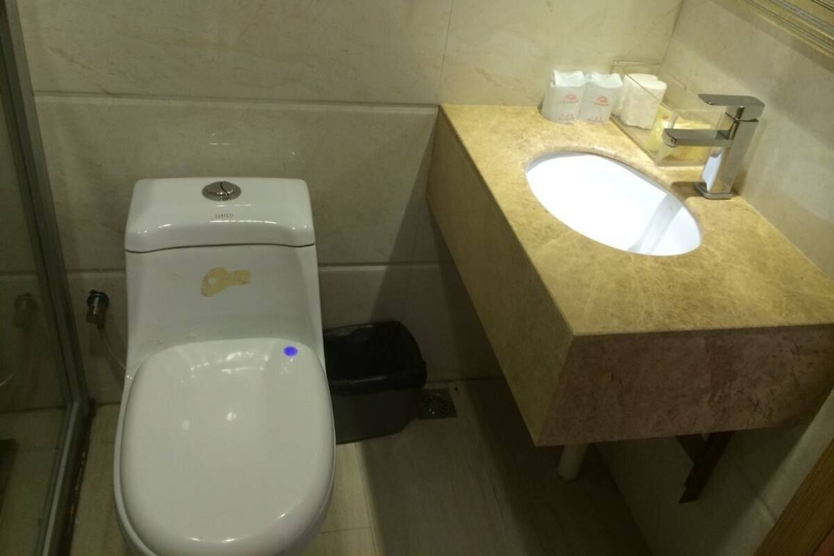 Quarto Twin Deluxe | Casa de banho | Um polibã, um chuveiro fixo, artigos de higiene pessoal grátis
