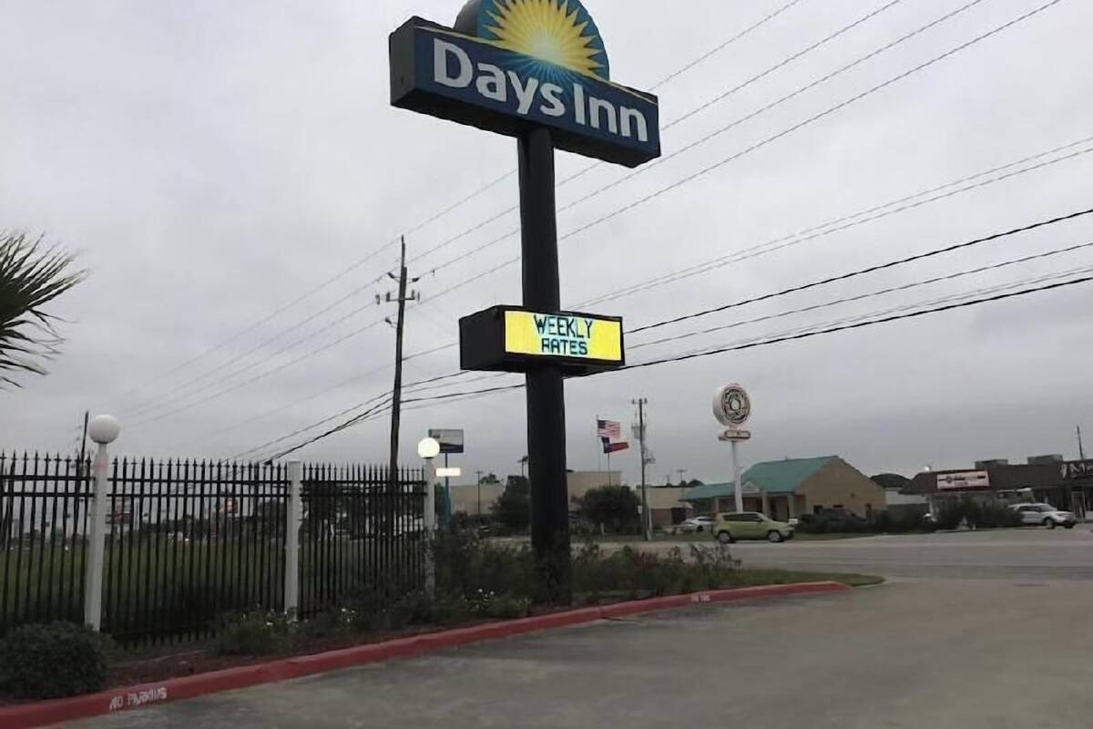 Placa da Days Inn com um anúncio de tarifas semanais abaixo.