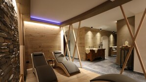 Uma sala de spa com piso de madeira, paredes de pedra e uma mesa de massagem.