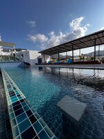 Piscina externa, guarda-sóis, espreguiçadeiras