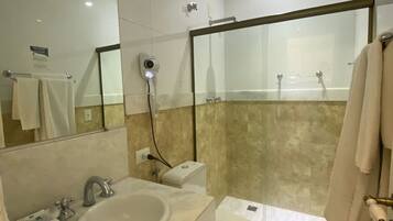 Uma casa de banho moderna com lavatório, sanita e cabine de duche com vidro.