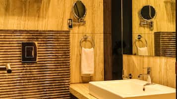 Quarto Twin Deluxe | Casa de banho | Um polibã, um chuveiro fixo, artigos de higiene ecológicos