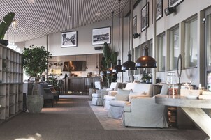 Um interior moderno com área de cozinha, espaço para sentar e bar.