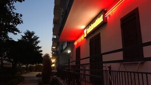 Um edifício com um letreiro de neon que diz "Hotel Breakfast Club".