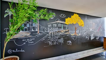 Um mural com uma planta e uma paisagem urbana.