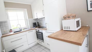 Casa | Cozinha privada | Uma cafeteira/bule, um frigorífico, um micro-ondas, um forno