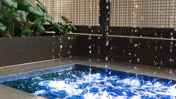 Piscina retangular com jatos de água criando um efeito dinâmico.