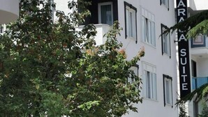 A modern building with the sign "KARASUITE" indicating a hotel or suite.