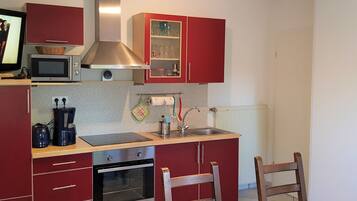 Apartamento | Cozinha privada | Cooktop, lava-louças