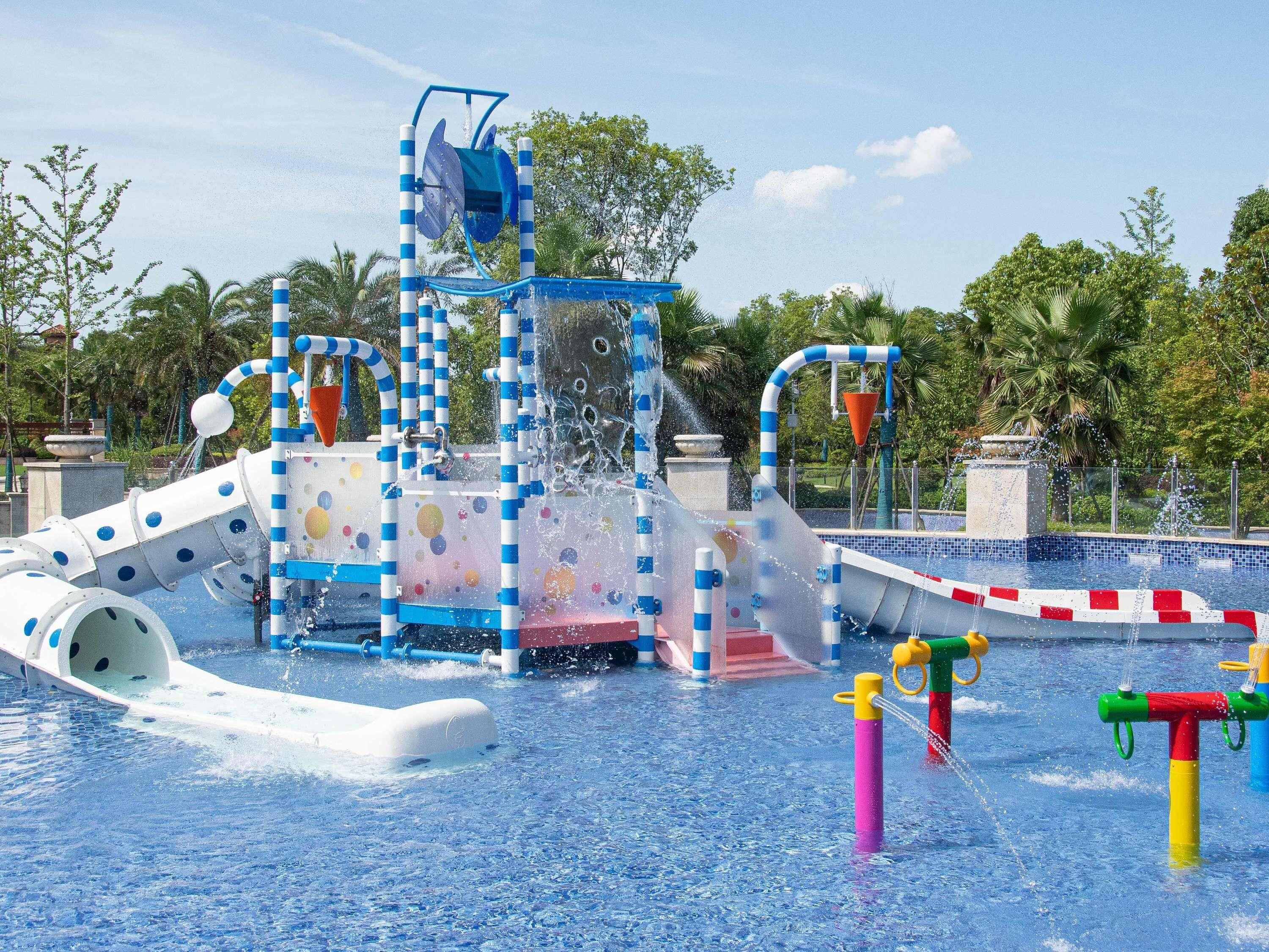 Parque aquático com toboáguas, jatos d'água e piscina.
