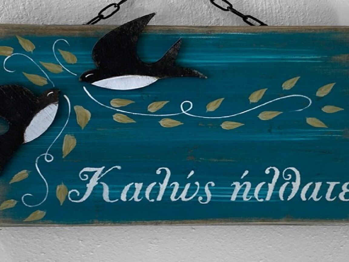 Um letreiro decorativo com orcas e o texto 'Kadis n'dara'.