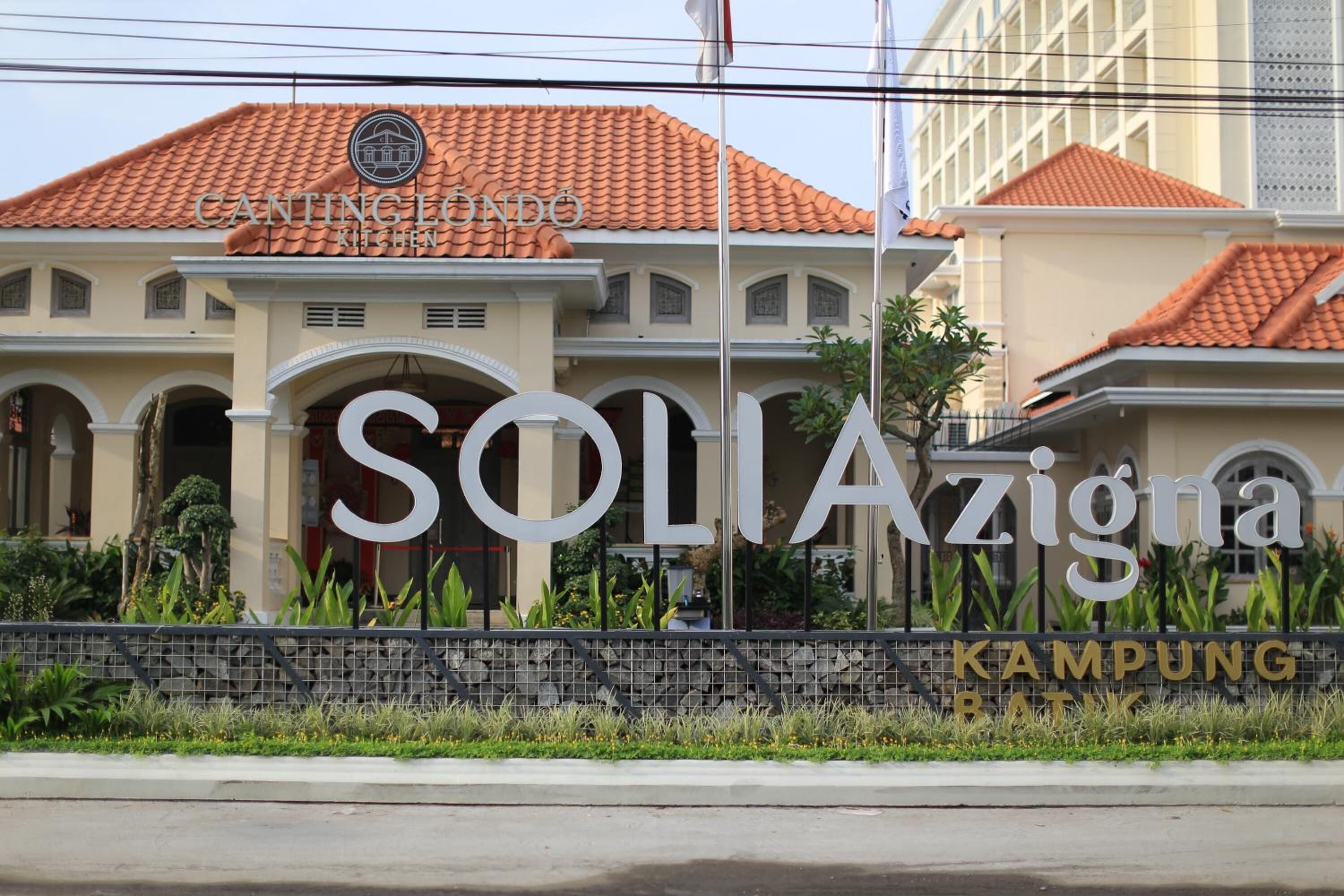 Um edifício com uma placa que diz 'Soli Azigna Kampung Batik'.