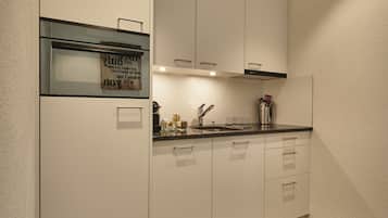 Um frigorífico/congelador grande, um micro-ondas, um forno