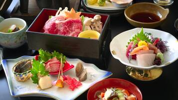 Diversos pratos em uma mesa, incluindo sushi, sashimi e outras iguarias, indicando uma experiência gastronômica.