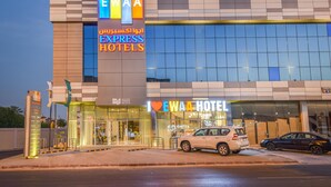 A hotel with a prominent sign reading "EWA HOTEL EXPRESS HOTELS" and a large illuminated heart symbol.
