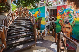 Uma escada de madeira com um mural na parede.