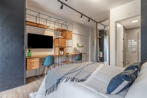Quarto moderno com uma cama, uma escrivaninha e uma cadeira.