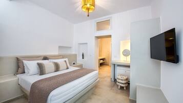 Quarto moderno com cama, mesa de cabeceira e televisão presa na parede.