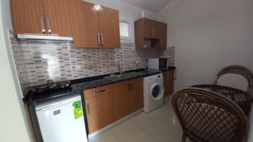 Apartamento família | Cozinha privada | Frigobar, fogão, chaleira elétrica