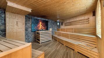 Uma sauna com bancos de madeira e parede de pedra.