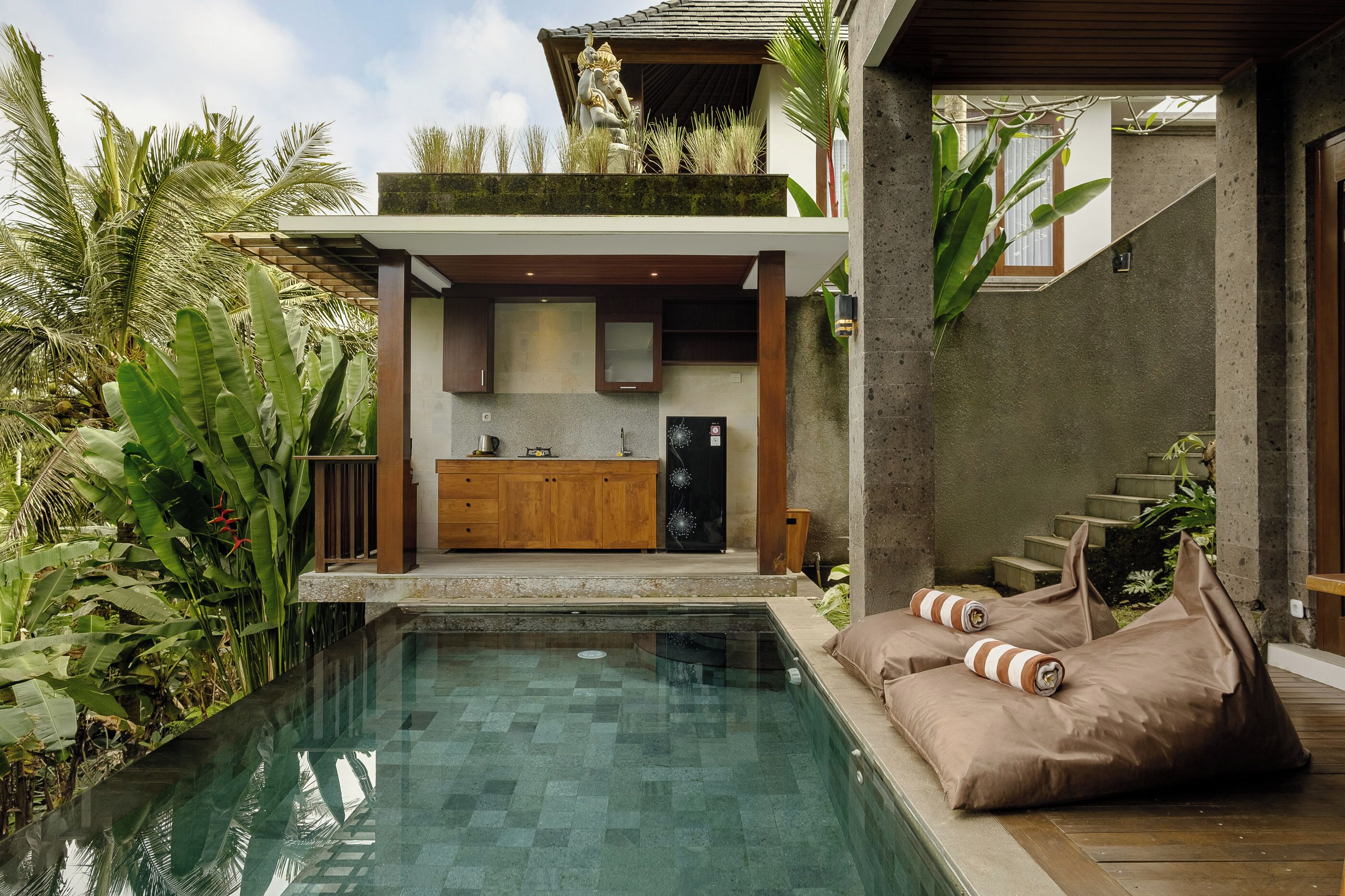Uma casa moderna com piscina, deck de madeira e escadaria.