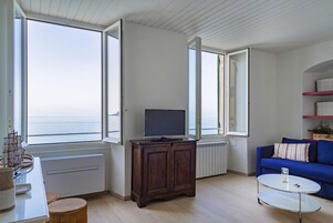 Apartamento, 1 quarto | Área de estar | TV de tela plana