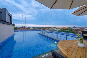 Piscina externa, guarda-sóis, espreguiçadeiras