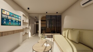 Suite Júnior, banheira de hidromassagem grande, vista para o mar | Sala de estar | Televisor, livros 