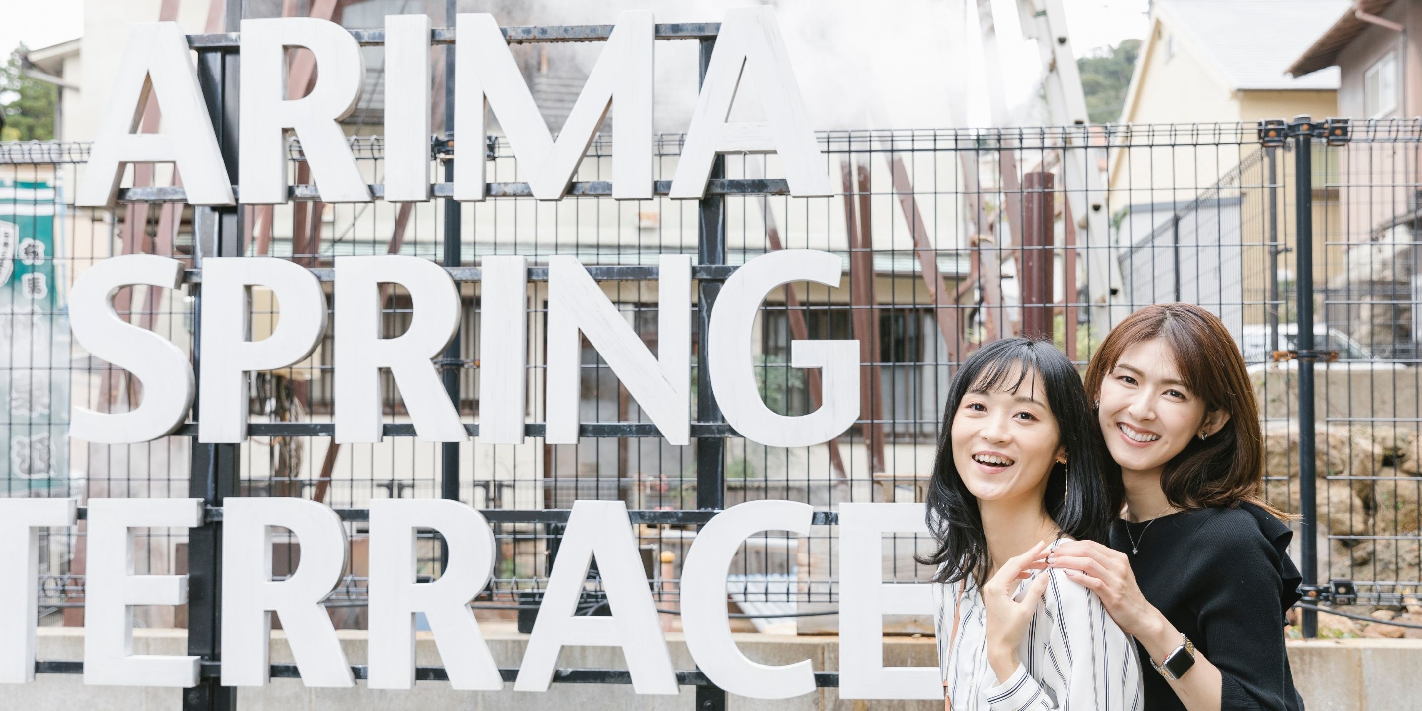 Uma placa com as palavras 'ARIMA SPRING TERRACE' em letras grandes.