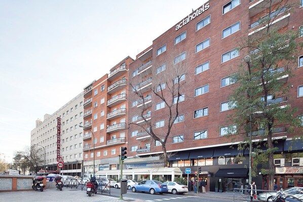 Um hotel de vários andares com fachada de tijolos, varandas e uma placa com o nome 'Hotel Floridant'.