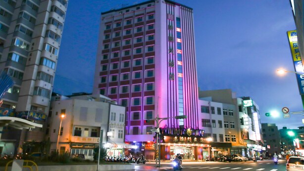Um hotel alto com design moderno, destacando um padrão de listras verticais na fachada.