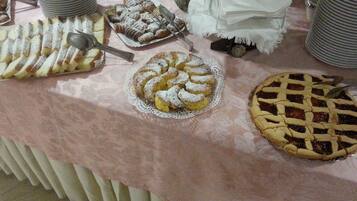 Mesa de buffet com diversos doces e uma torta.